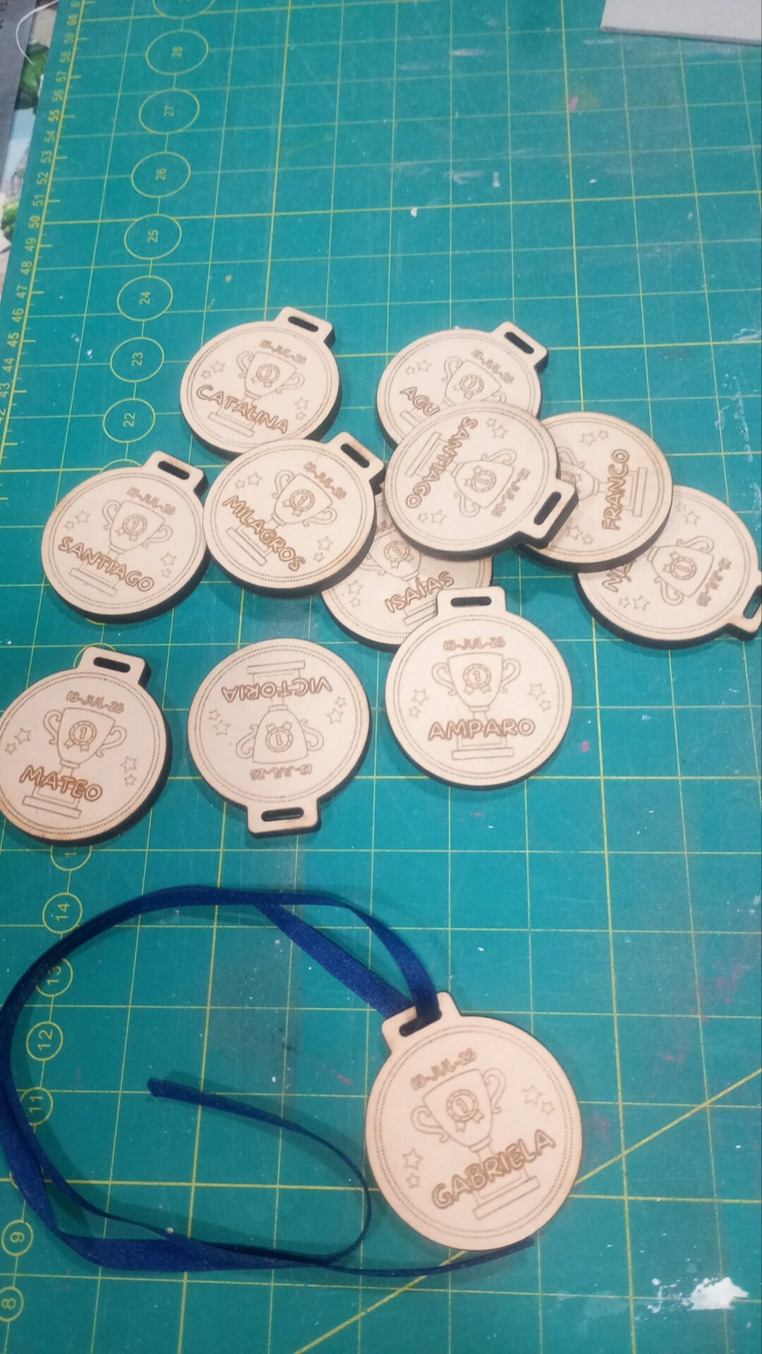 medallas grabadas en MDF souvenirs - Nika estudio online